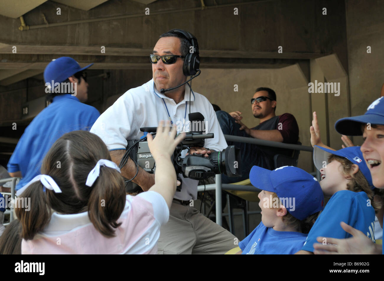 Video camera crew checks big screen while transmitting images of ...