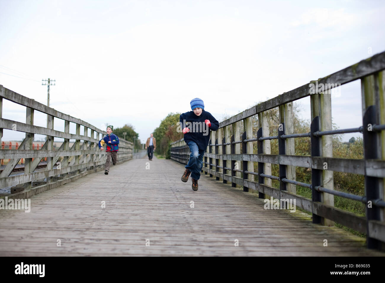 Two boys race over a bridge in Northamptonshire MODEL RELEASE AVAILABLE ...