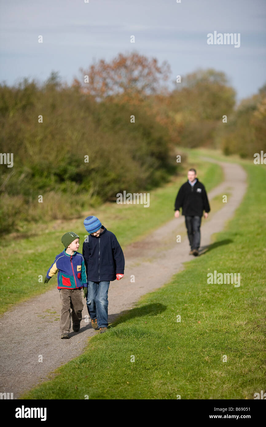 Two boys and their father walk along a path in Northamptonshire MODEL ...