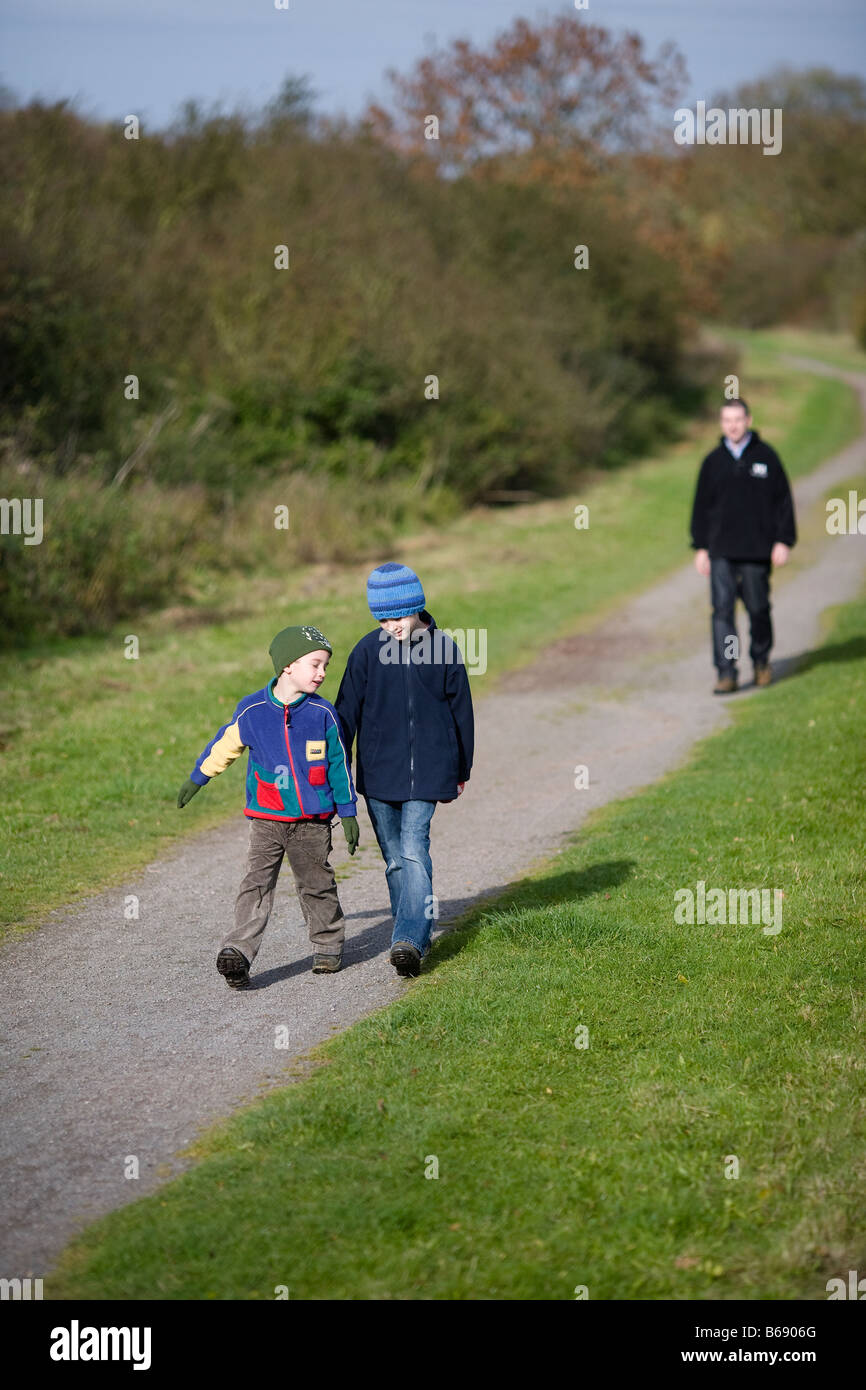 Two boys and their father walk along a path in Northamptonshire MODEL ...