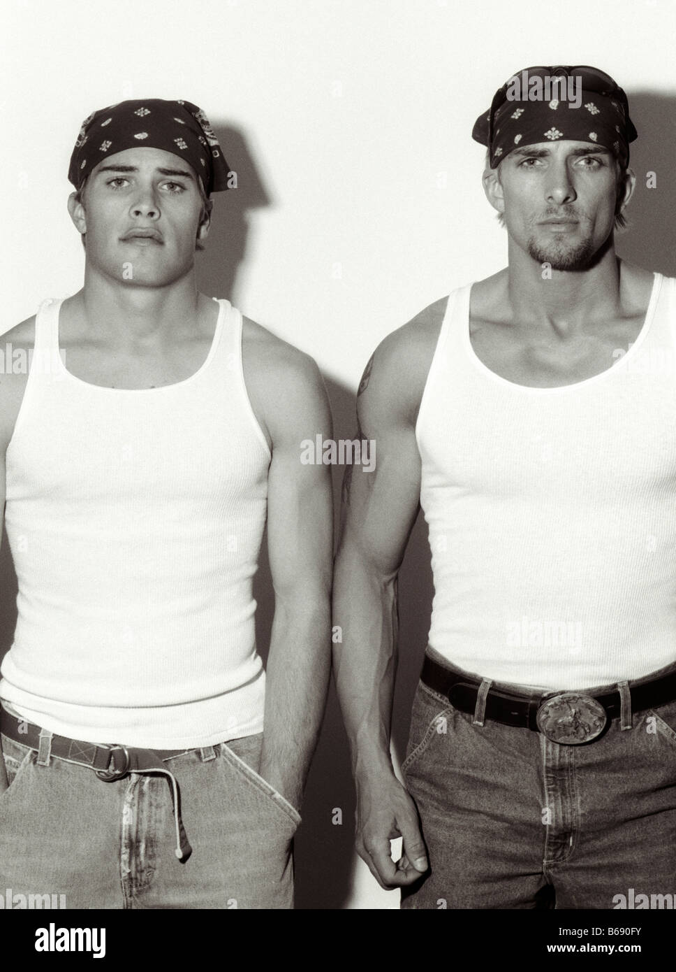 Two men standing by wall, portrait Stock Photo - Alamy