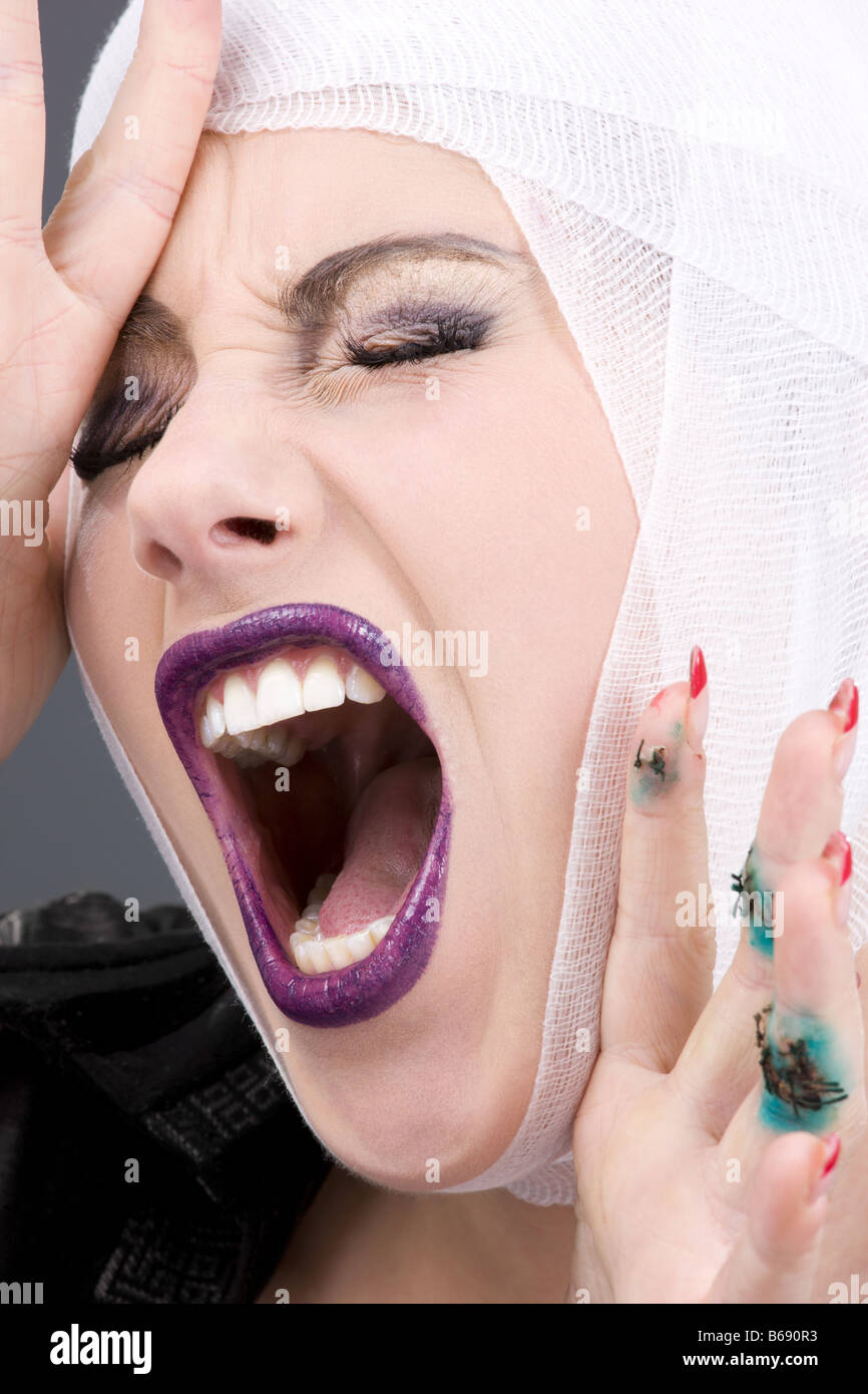 picture of screaming wounded woman face over grey Stock Photo - Alamy