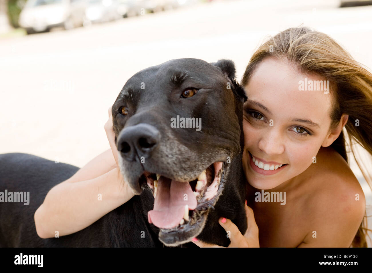 Young woman embracing dog Stock Photo - Alamy