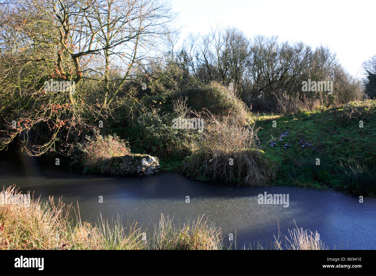 Earthworks, moat and flint walls at Norman motte and bailey castle at ...