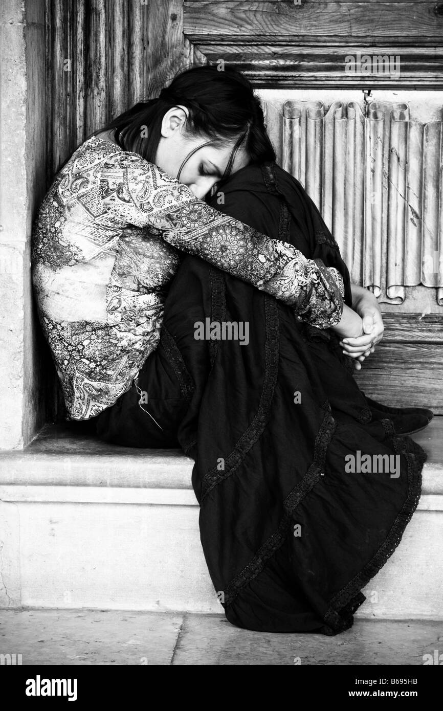 Sad elegant woman sitting and crying Stock Photo - Alamy