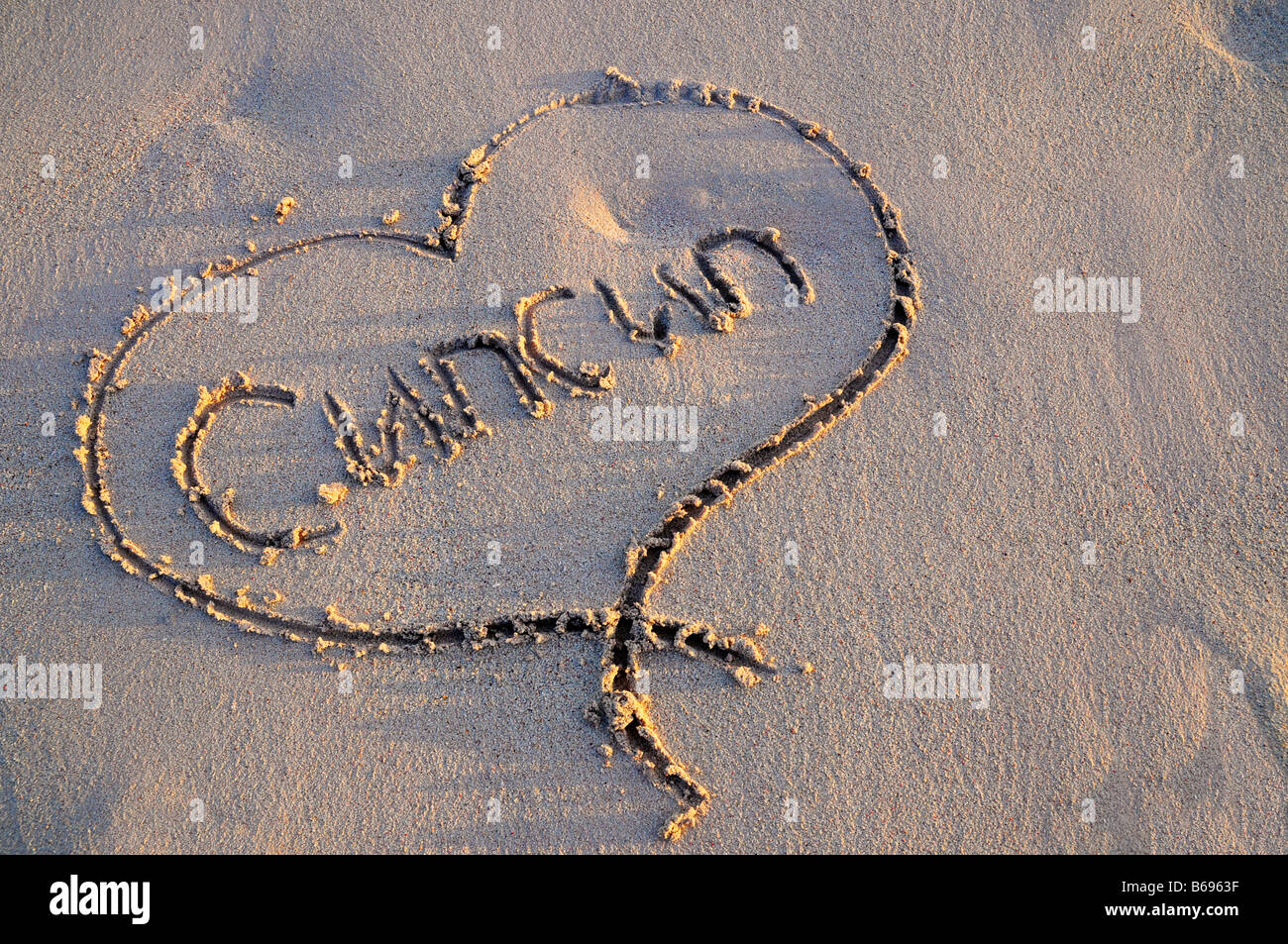 Cancun sand writing on a beautiful sunset beach Stock Photo - Alamy