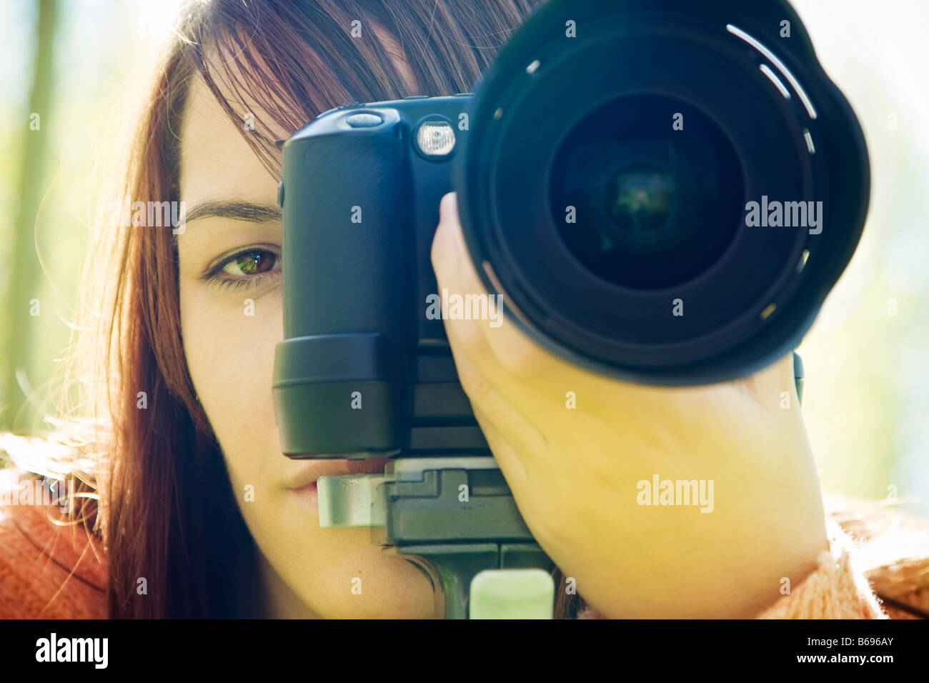 Young woman eye behind slr camera Stock Photo - Alamy