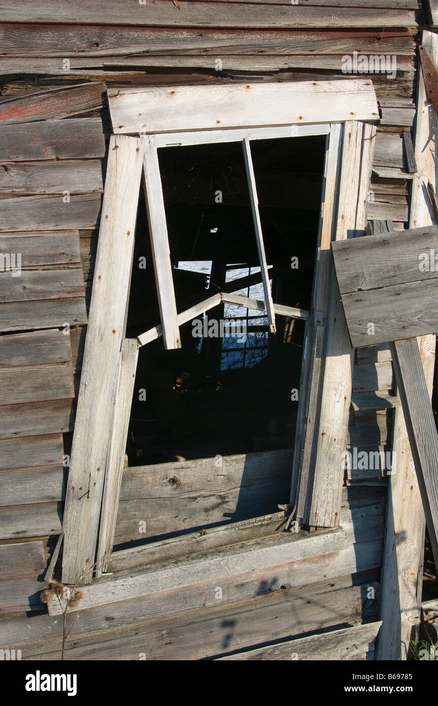 Collapsing empty window frame in a collapsing wooden barn Close up ...