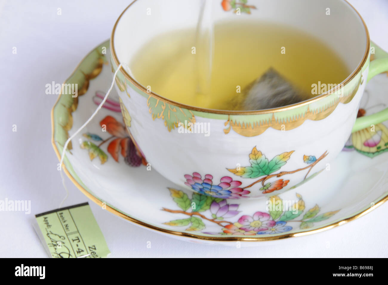 Pouring water into tea cup Stock Photo - Alamy