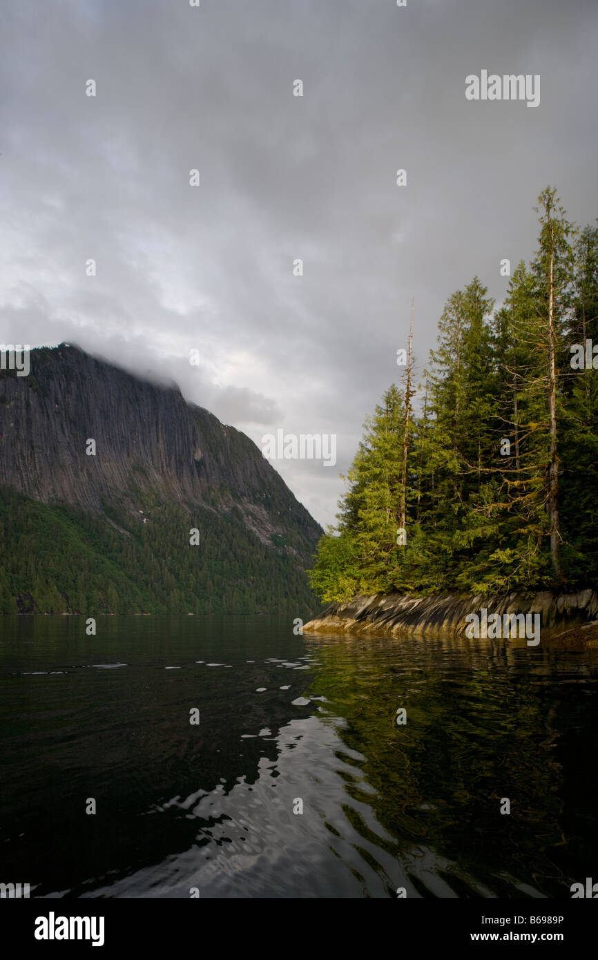 USA Alaska Misty Fjords National Monument Setting sun lights rainforest ...