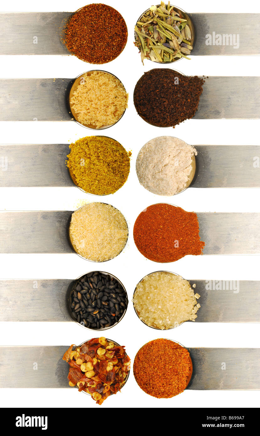 Twelve powdered ingredients in teaspoons isolated on white background ...