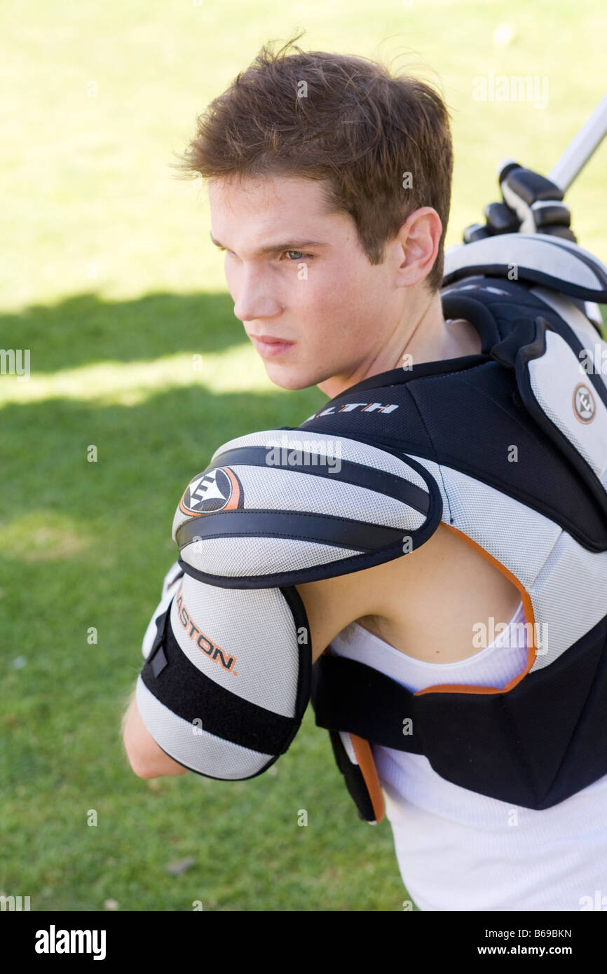 Young man holding lacrosse racket, smiling Stock Photo - Alamy