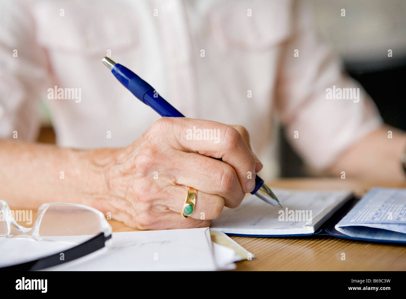 Woman writing on a diary Stock Photo - Alamy