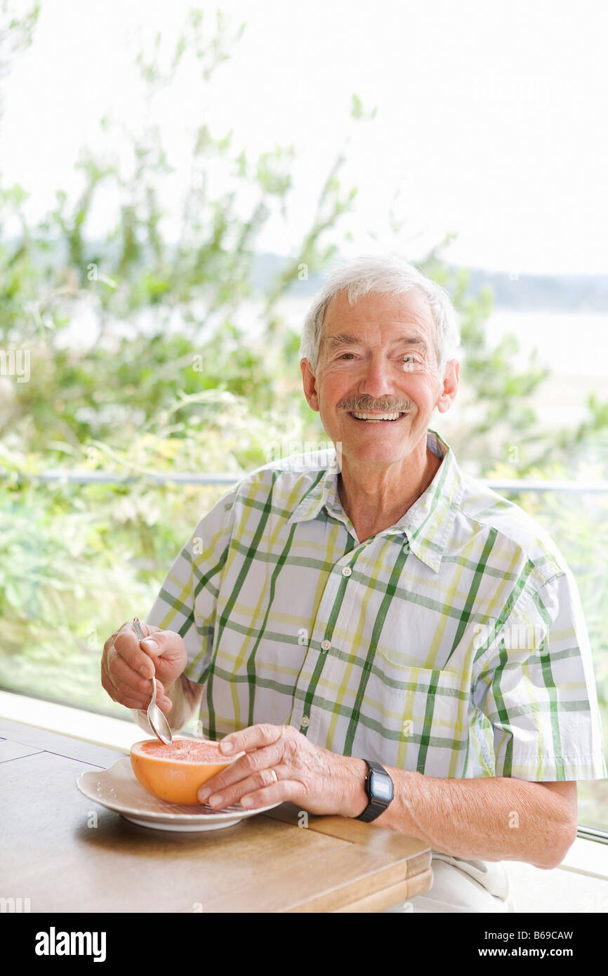 Man eating a grapefruit Stock Photo - Alamy