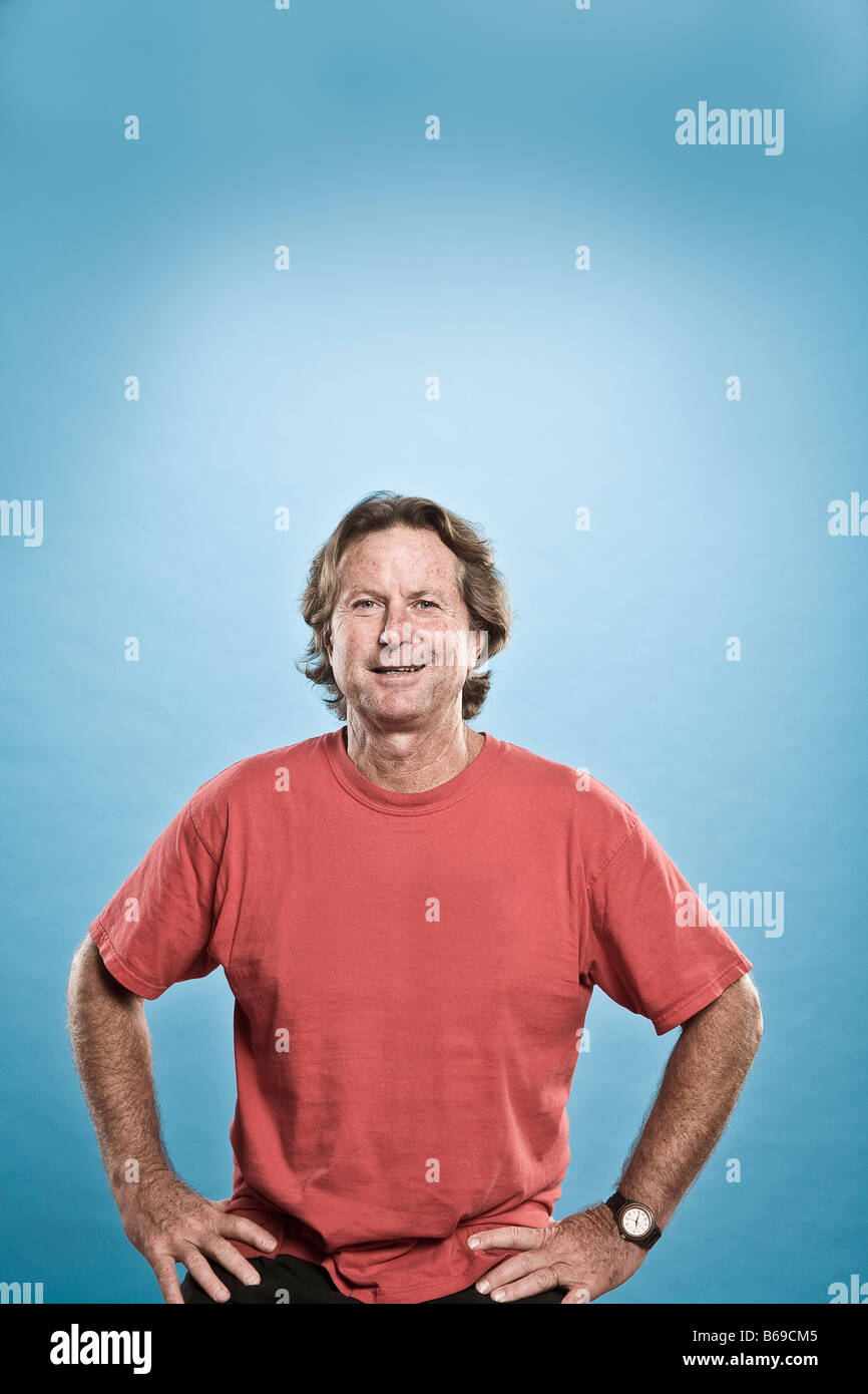 Portrait of a man sitting with arms akimbo Stock Photo - Alamy