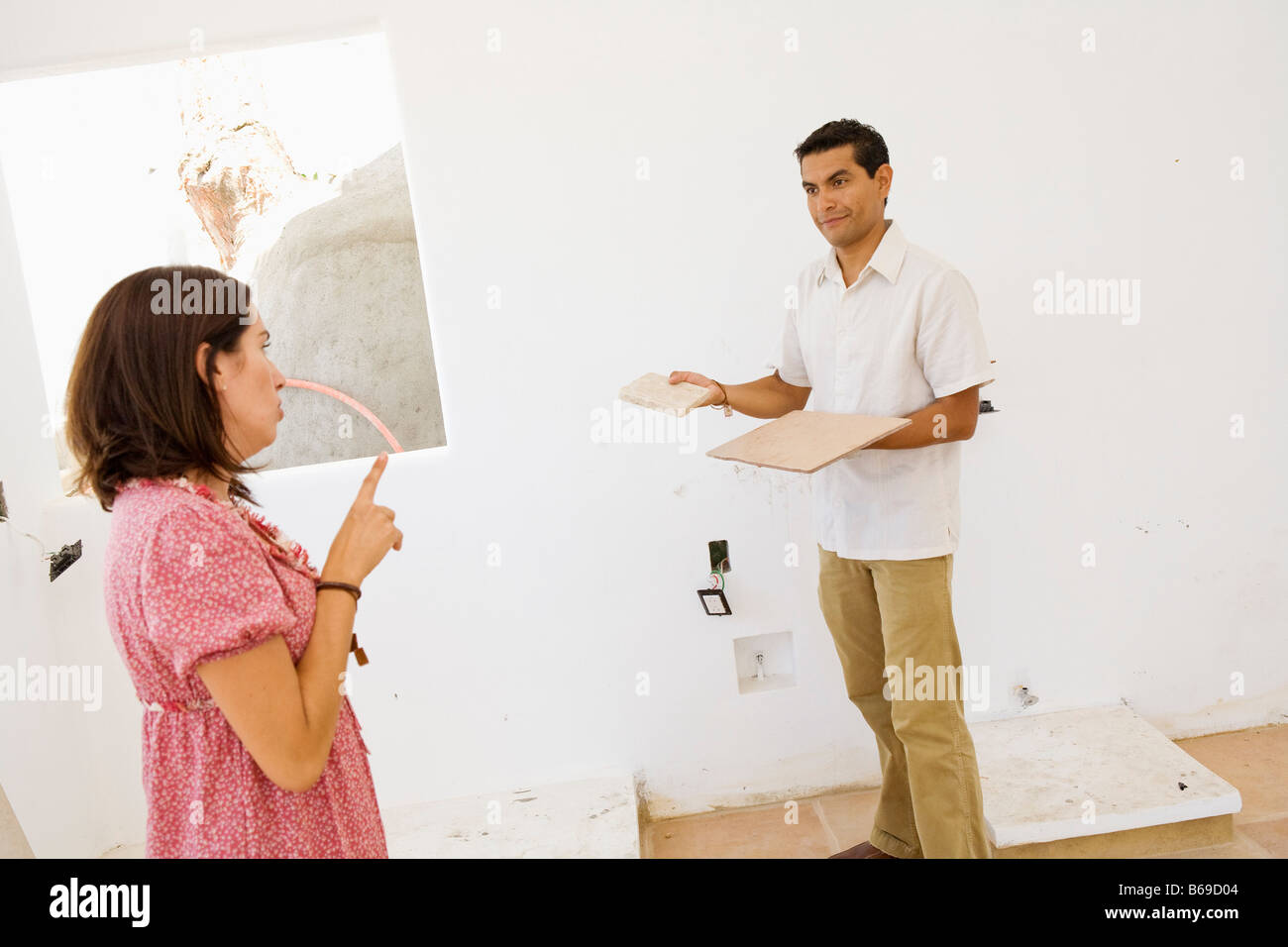 Couple choosing tiles Stock Photo - Alamy