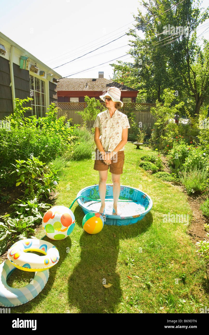 Woman standing in a wading pool Stock Photo - Alamy