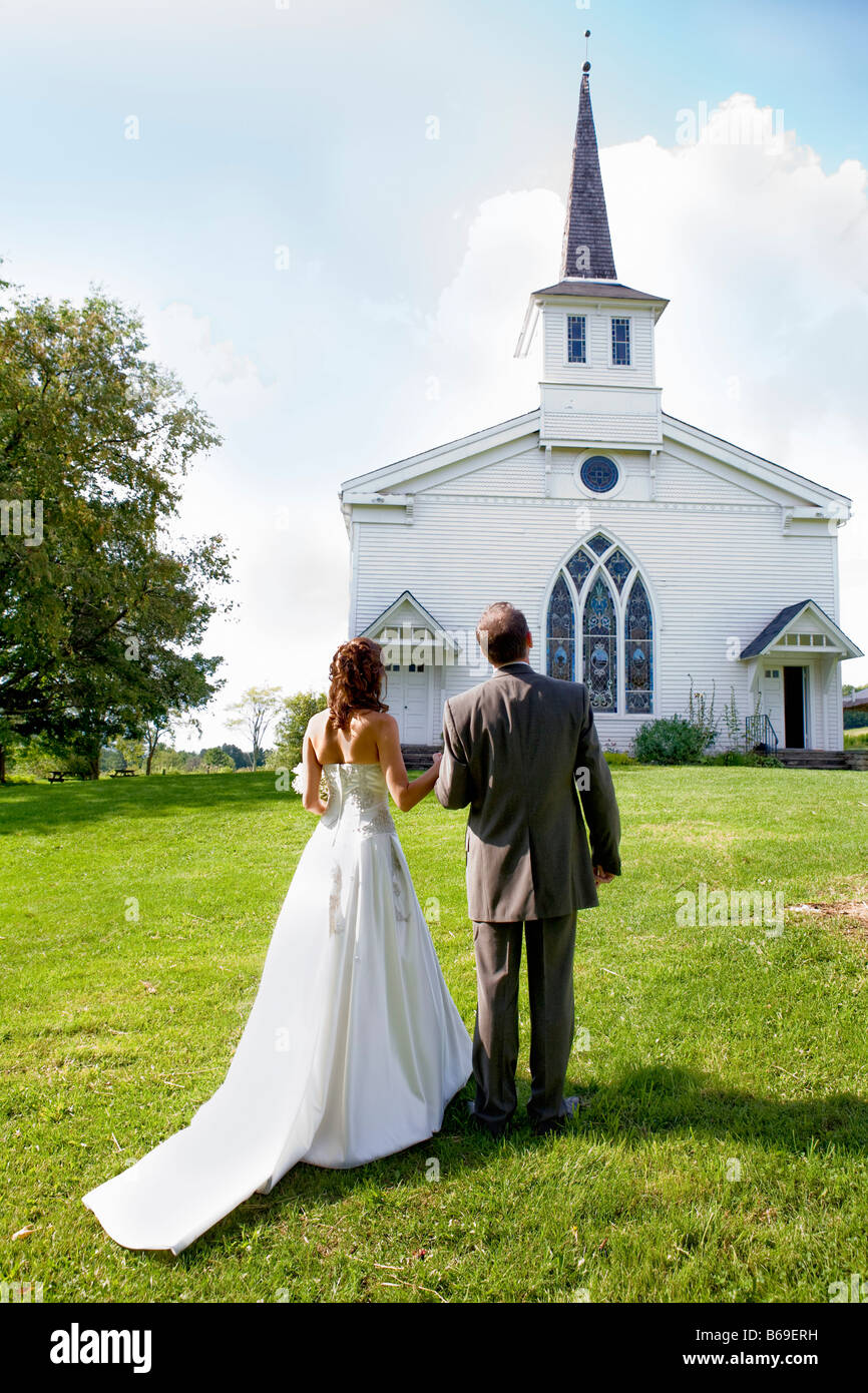 Newlywed couple standing in front of a church, East Meredith, New York ...