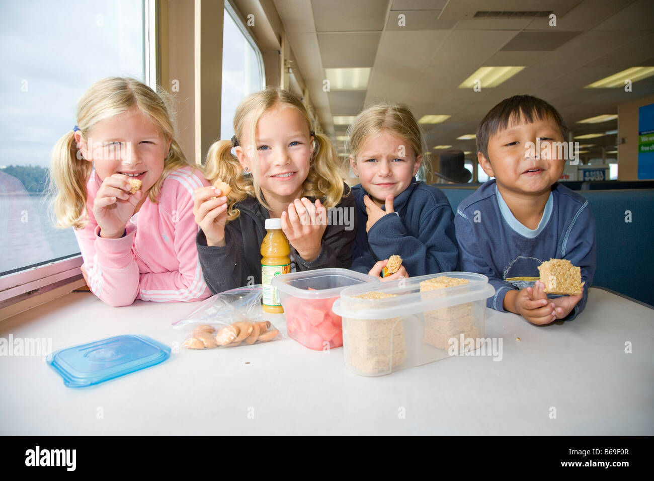 Children eating cookies and candies in a boat Stock Photo - Alamy
