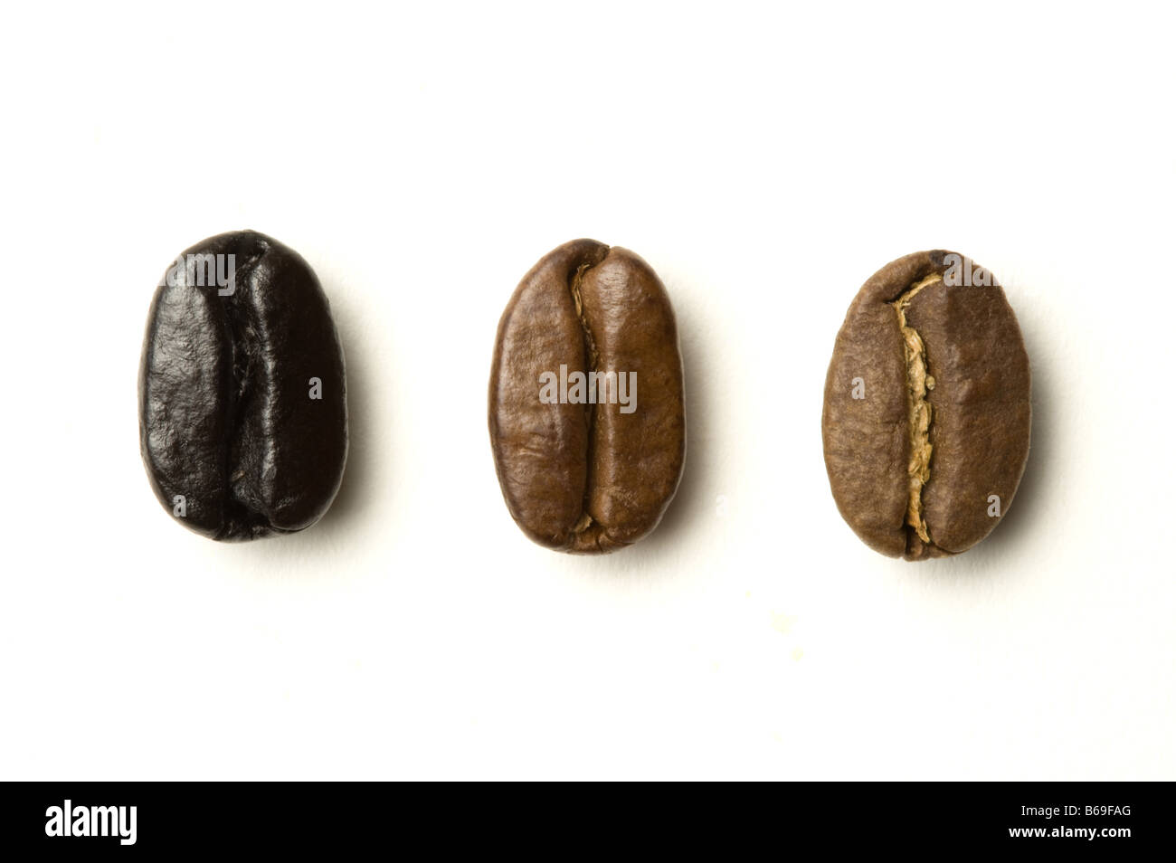 Close up of three coffee beans in white background Stock Photo - Alamy