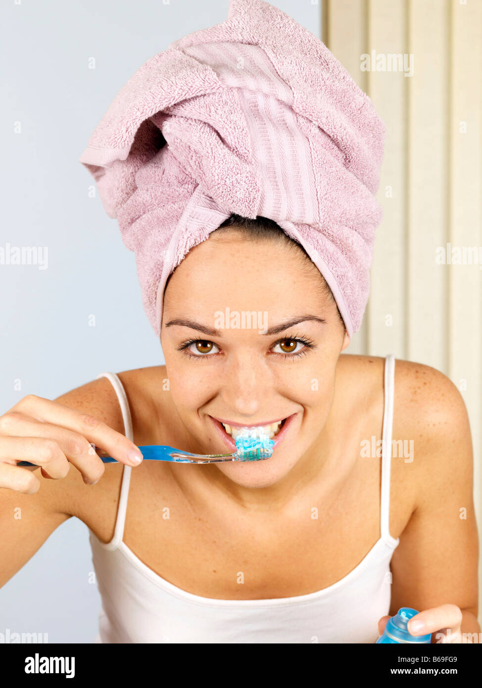 Young Woman Brushing Her Teeth With A Toothbrush And Toothpaste Caring For Dental And Oral