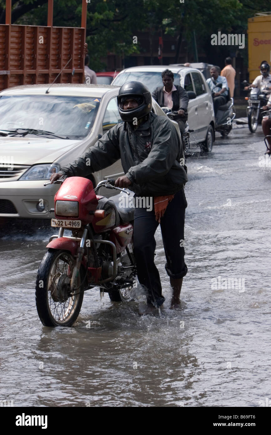 A man pushing his motorbike on a flooded road in Chennai Stock Photo ...