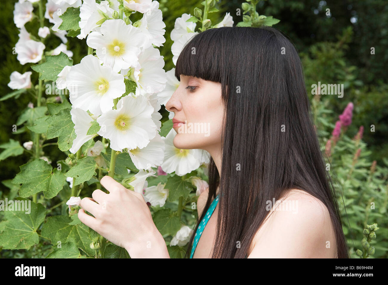 Profile woman sniffing flower hi-res stock photography and images - Alamy