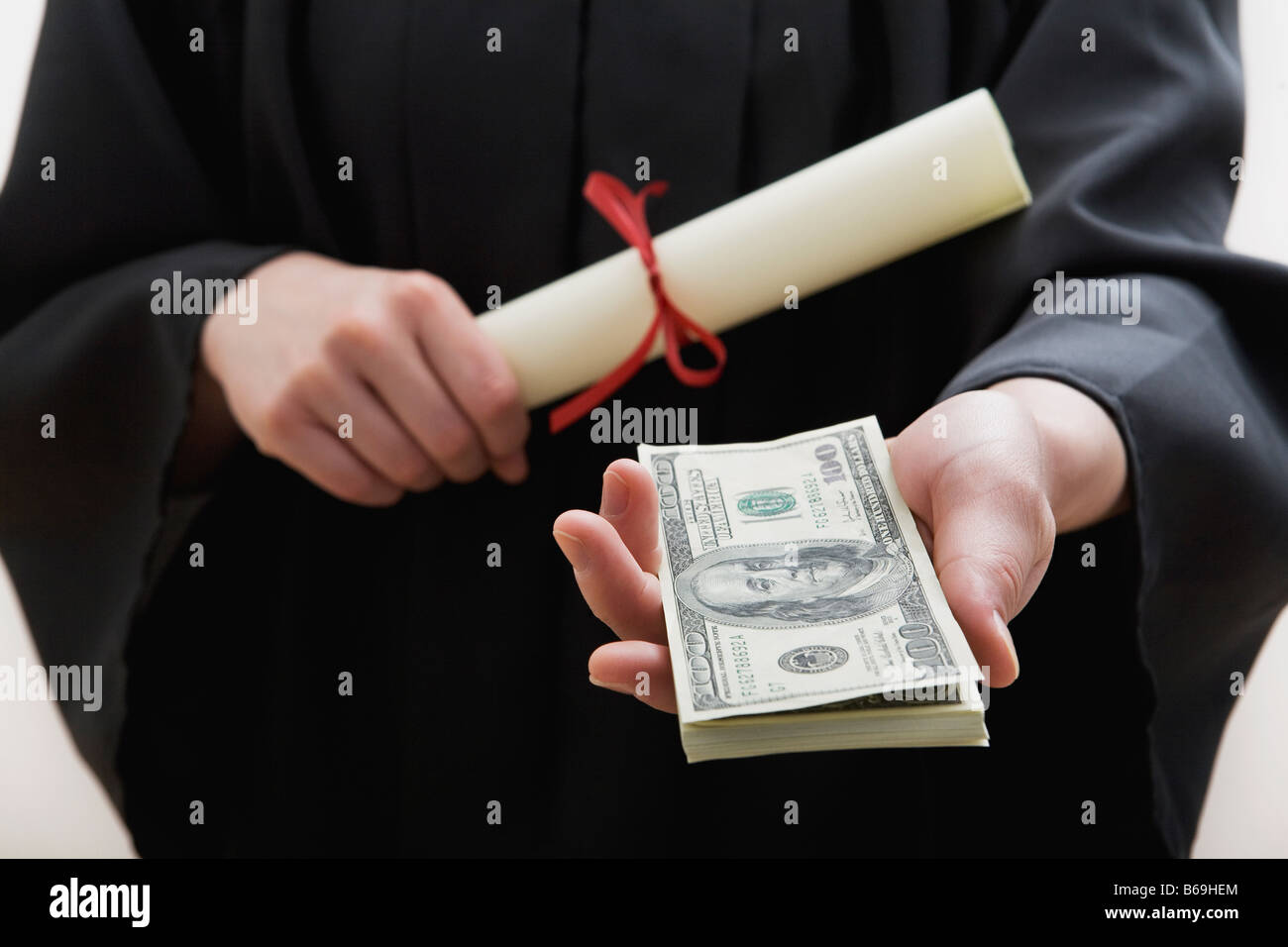 Female graduate student holding money hi-res stock photography and ...