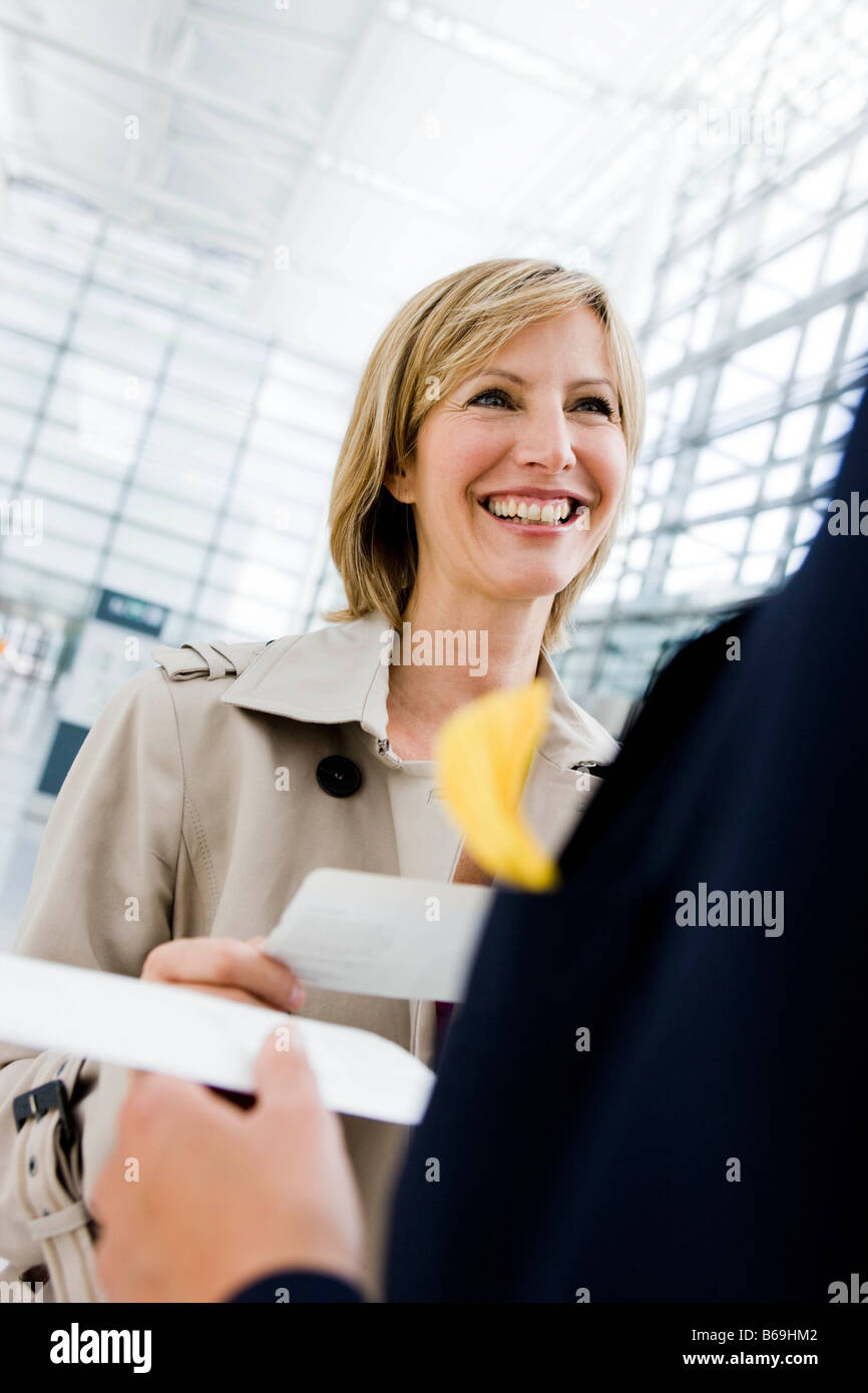 Woman checking in Stock Photo - Alamy