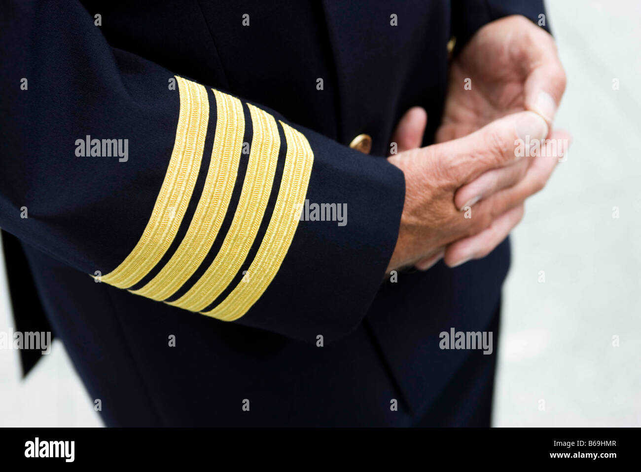 Flight captains hands folded Stock Photo - Alamy