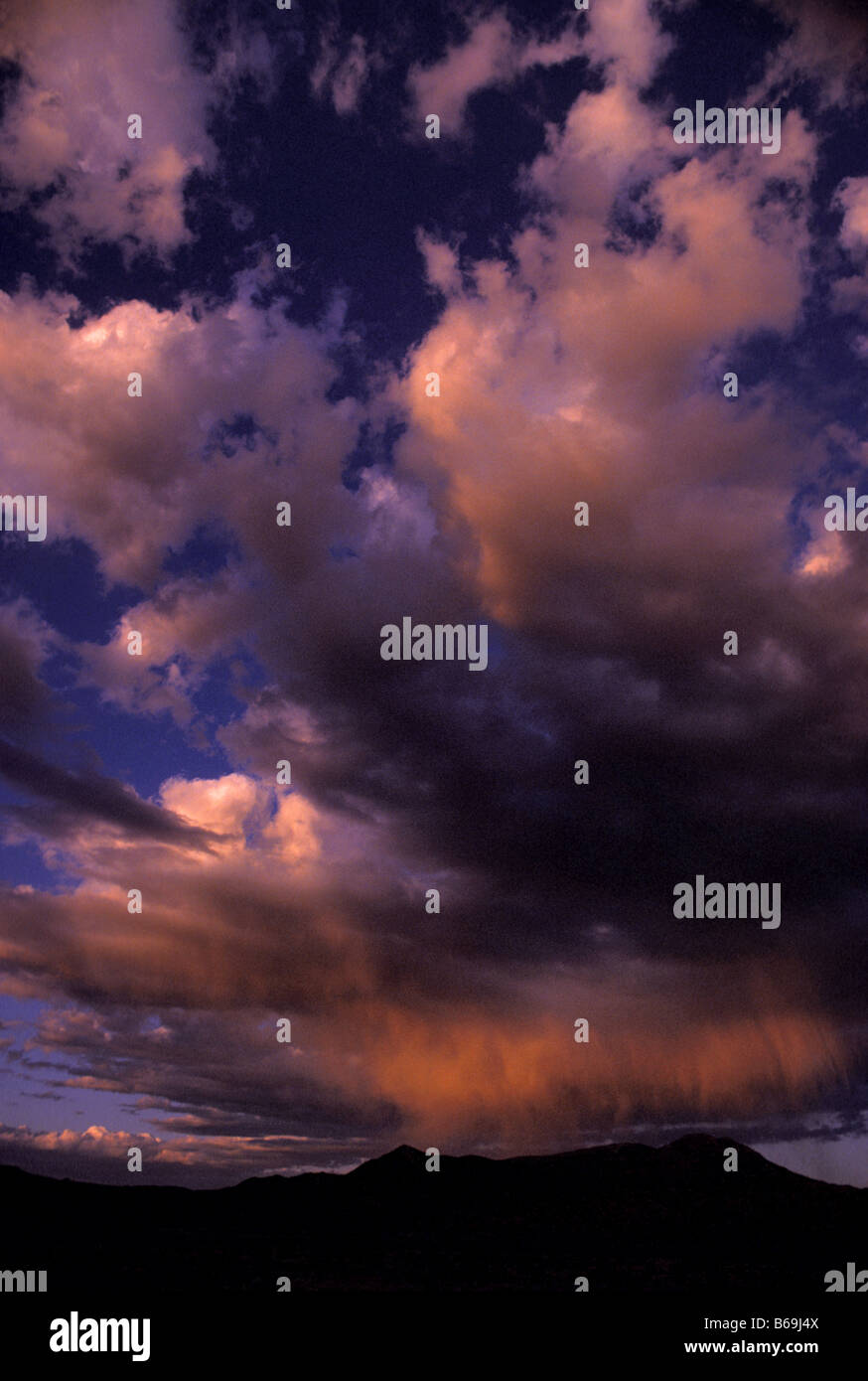 Evening summer thunderhead storm clouds with rain over mountains, Utah ...