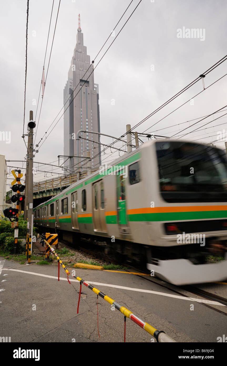 NTT DoCoMo Yoyogi Building (background) and a train in movement on a ...
