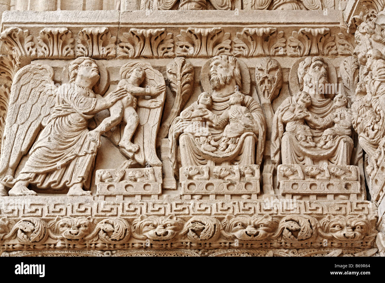 Romanesque stone bas relief on portal of the Saint Trophimus cathedral ...