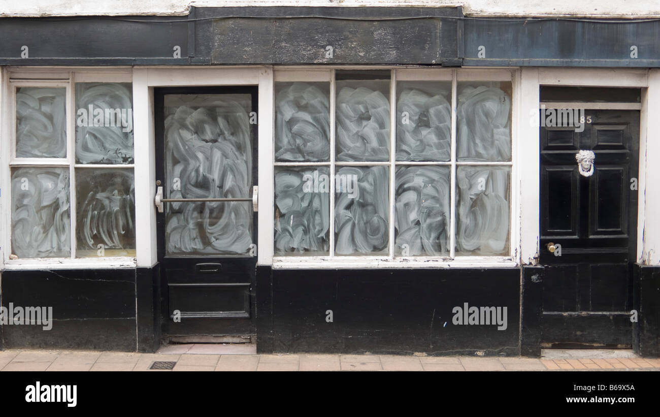 Empty shopfront with whitewashed windows Stock Photo - Alamy