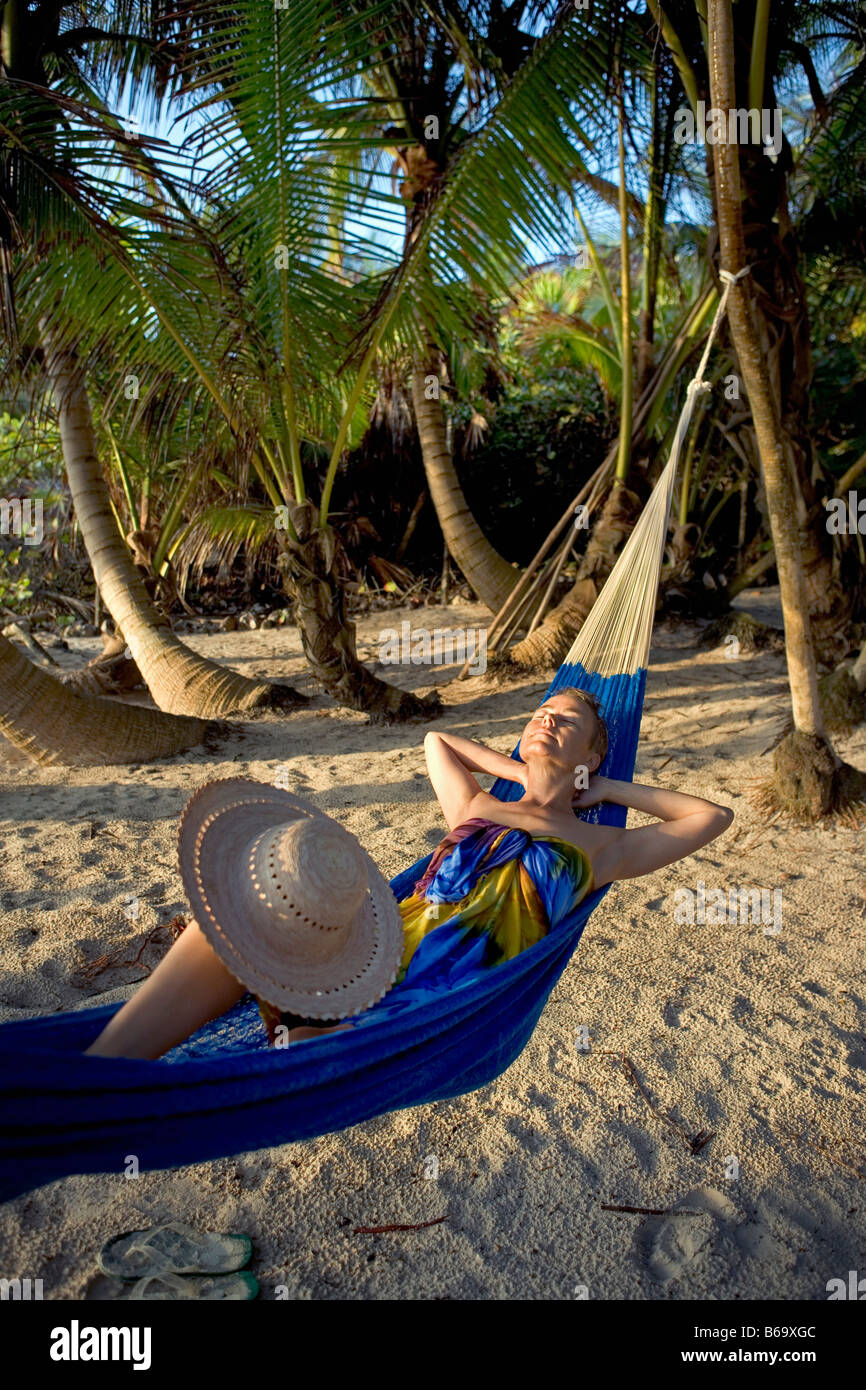 Mexico, Quintana Roo, Tulum, Tourist (woman) in hammock under palm ...