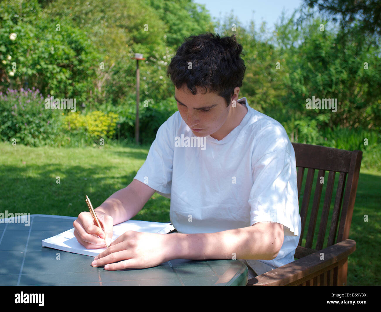 Teenage Boy Writing Stock Photo - Alamy