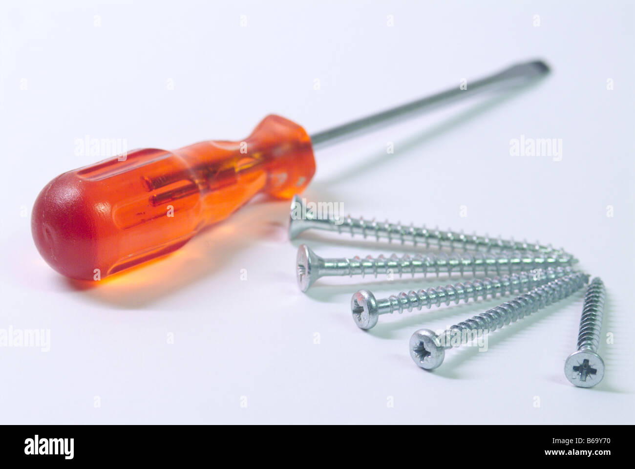 Screwdriver and Five Screws Stock Photo - Alamy