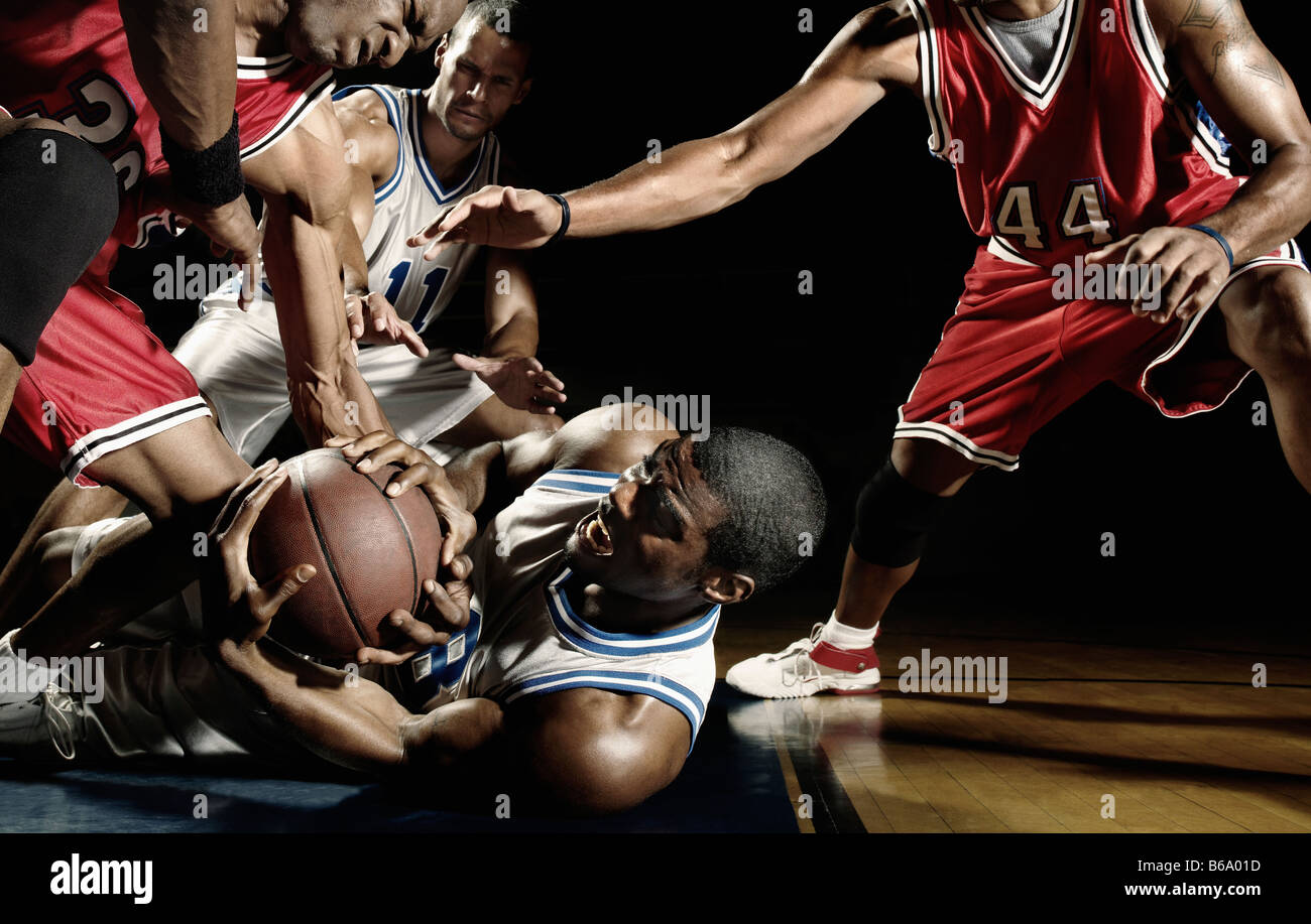 Multi-ethnic basketball players struggling for basketball Stock Photo ...