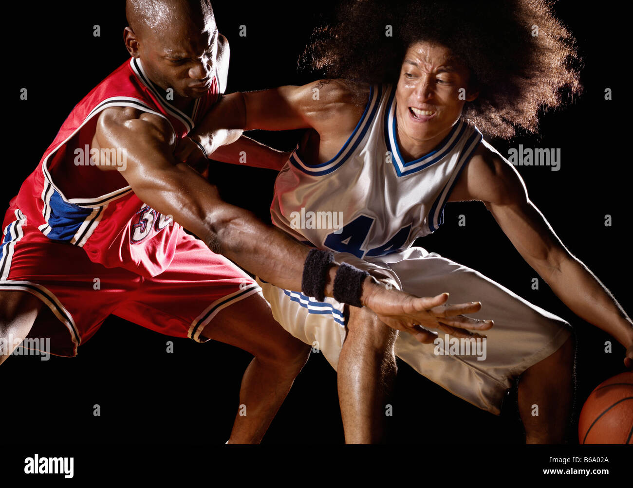 Multi-ethnic basketball players competing for basketball Stock Photo ...