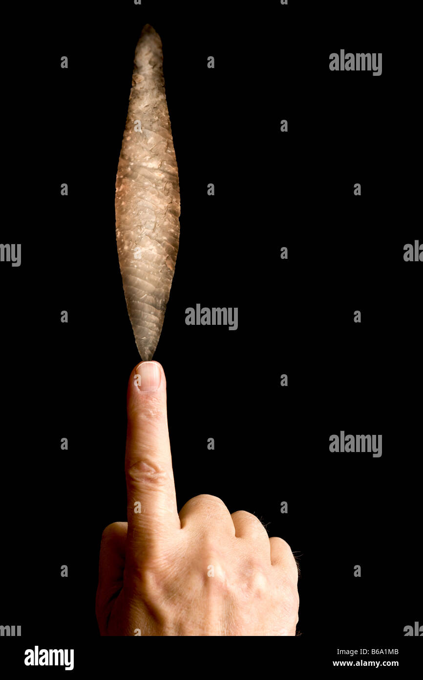 Balancing a flint dagger at the fingertip Stock Photo - Alamy