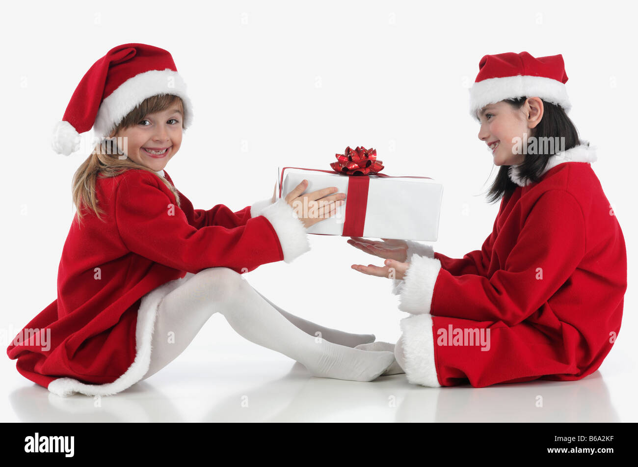two girls dressed as Santa Claus isolated on white background Stock ...