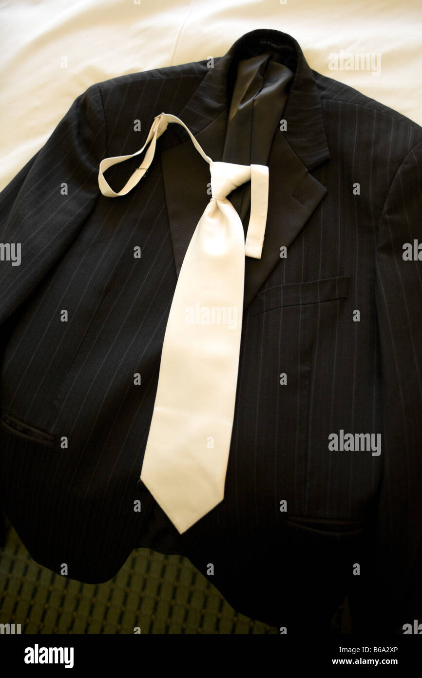 A White tie on a black suit Stock Photo - Alamy