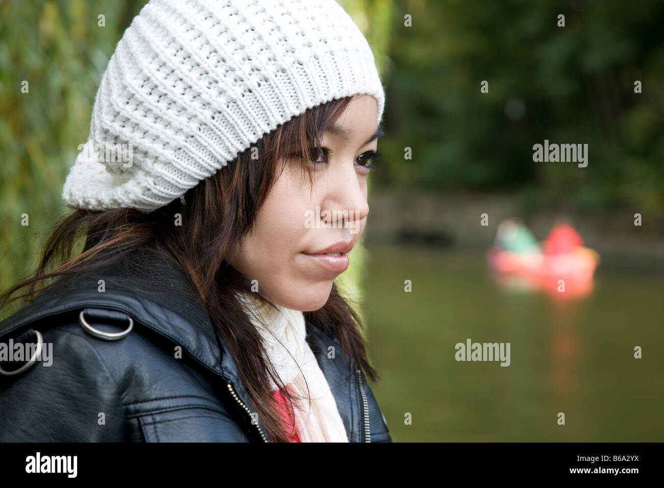 Russian oriental girl sat thinking by a canal Stock Photo - Alamy