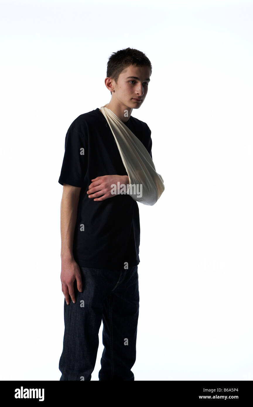 A teenager with a sling on his arm shot in a studio Stock Photo - Alamy