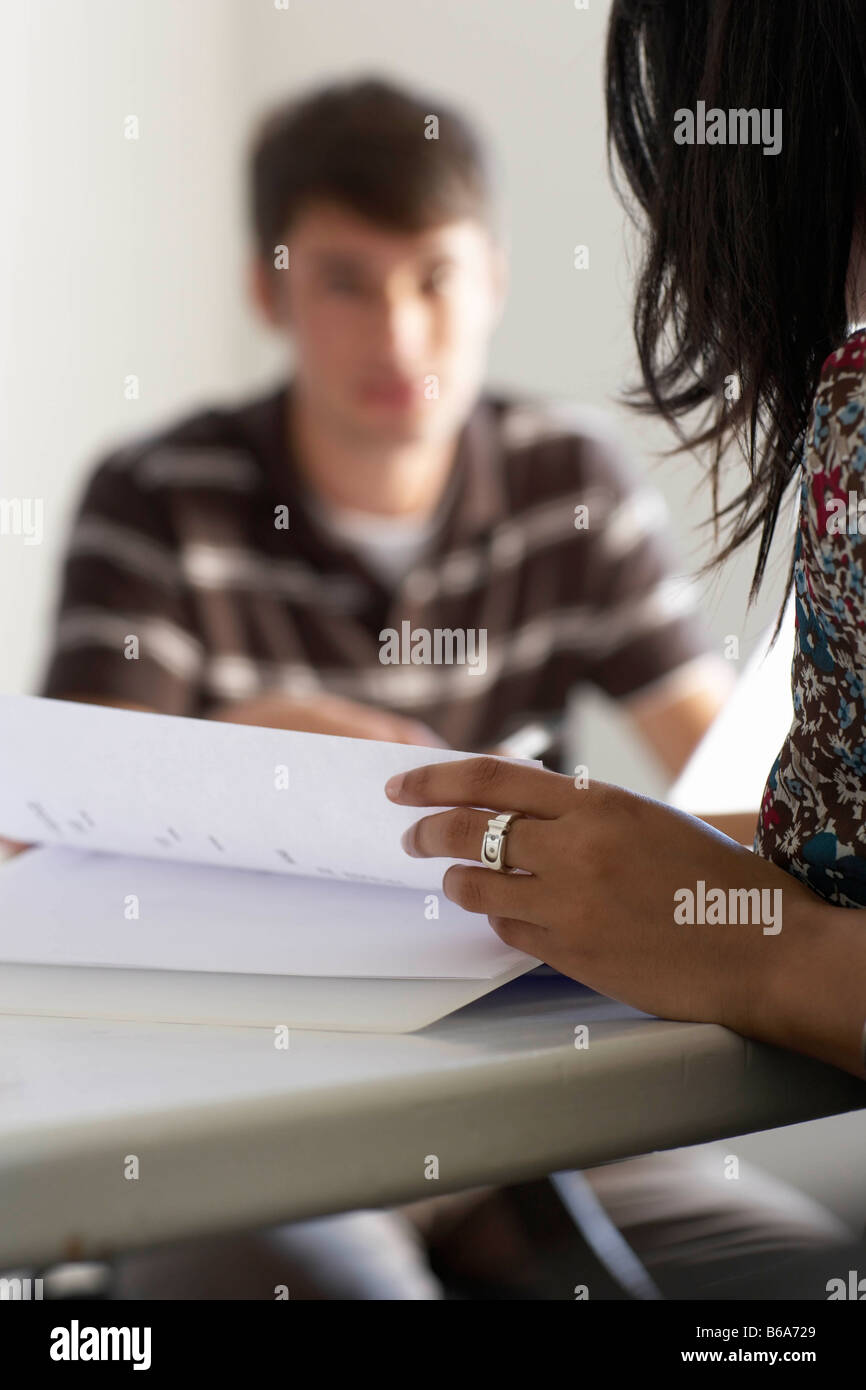 Sitting holding document reading concentration looking down hi-res ...