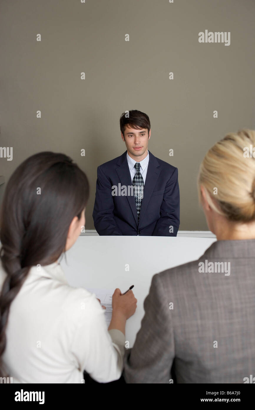 2 businesswomen interviewing man Stock Photo - Alamy