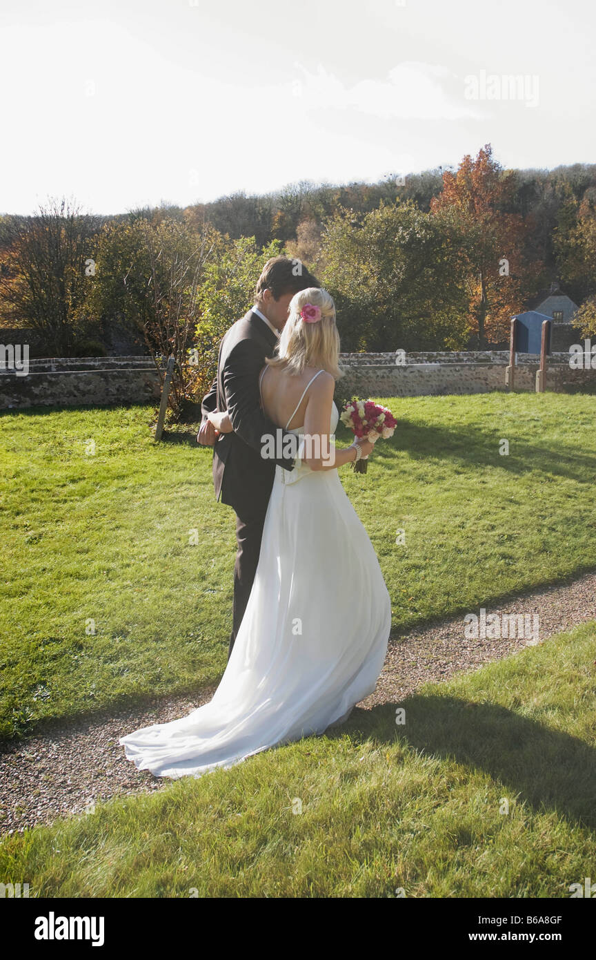 A wedding couple walking along a path Stock Photo - Alamy