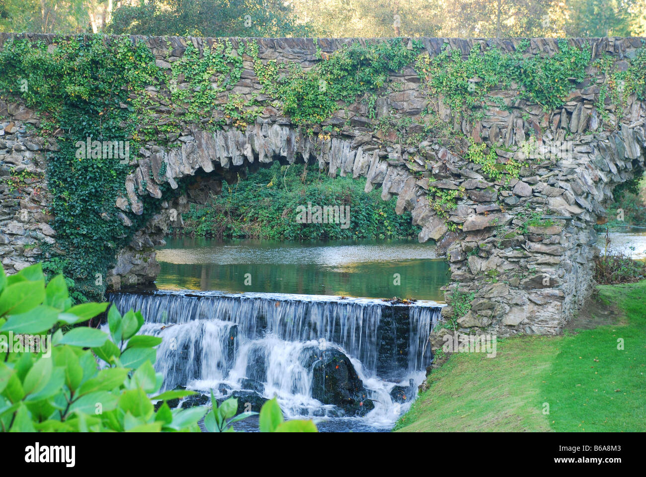 A waterfall and rock bridge on the Druids Glen golf course in County ...
