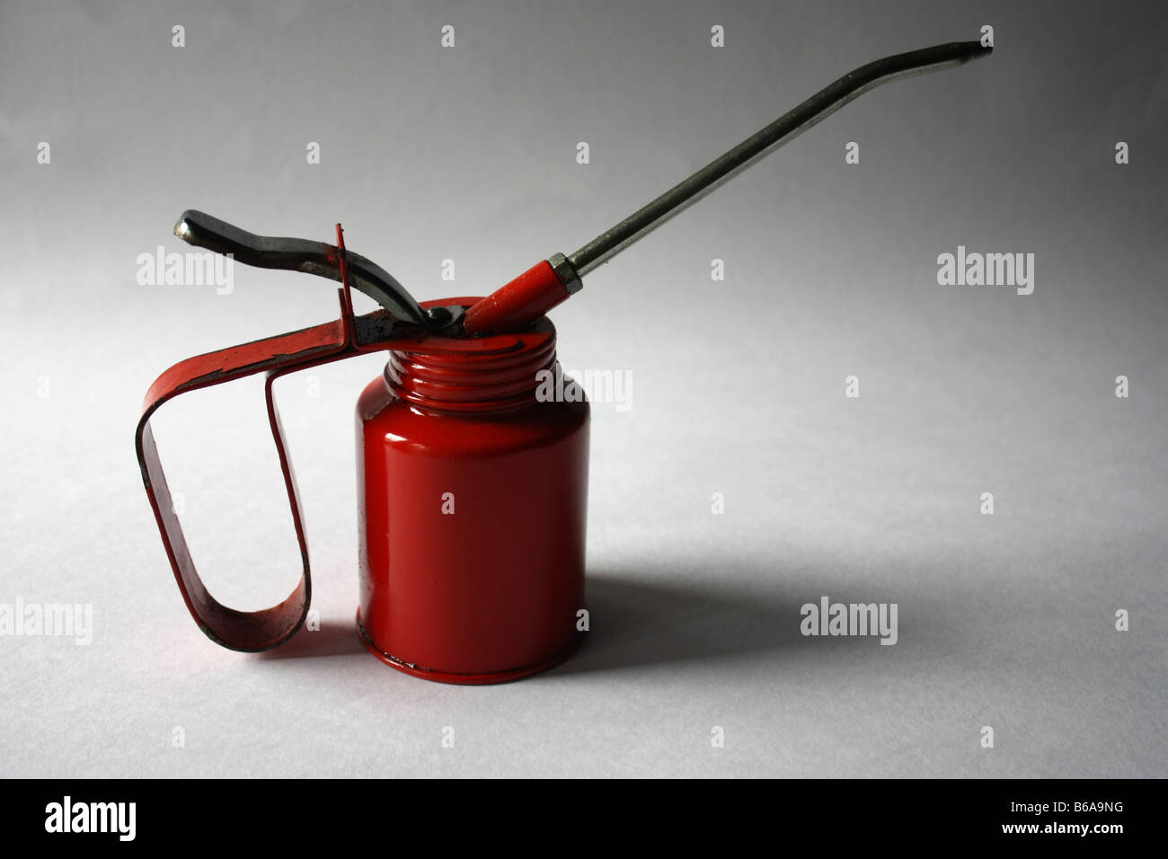 A Red Oil pouring equipment Stock Photo - Alamy