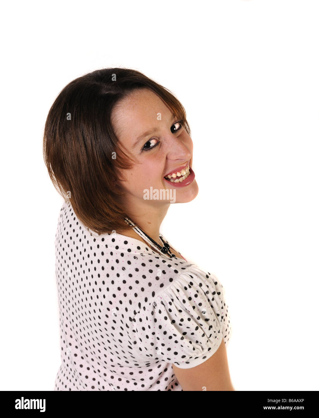 Teen girl looking over shoulder smiling Stock Photo - Alamy